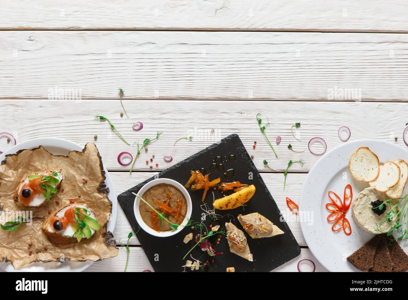 Various appetizers on free wood space Stock Photo - Alamy