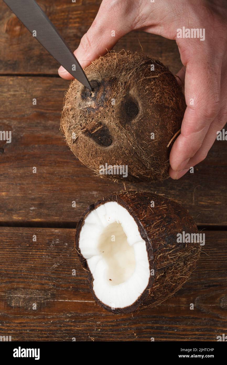 Close up coconut in process of opening Stock Photo - Alamy