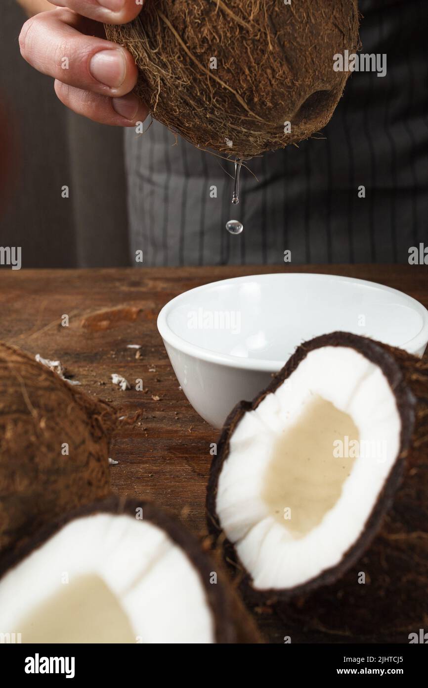 Fresh coconut water pouring into white bowl Stock Photo - Alamy