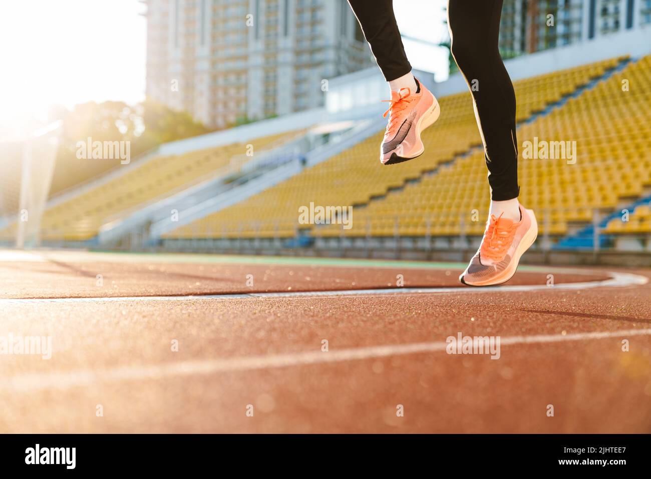 Young white sportsman running while working out on stadium outdoors ...
