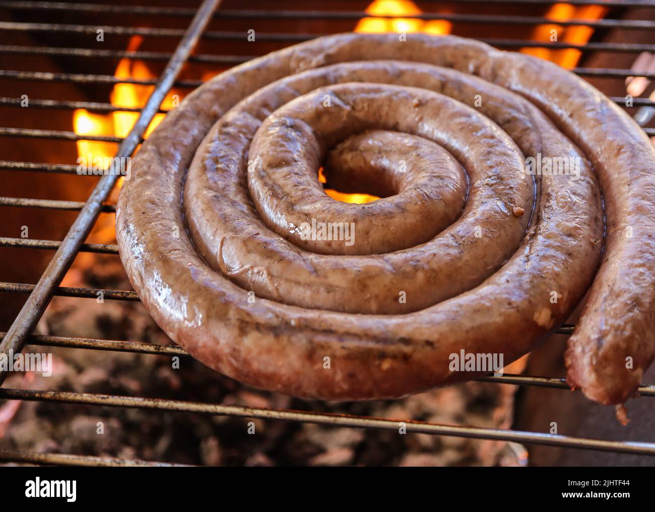 Boerewors sausage on a braai. Boerewors or braai wors, a South African ...