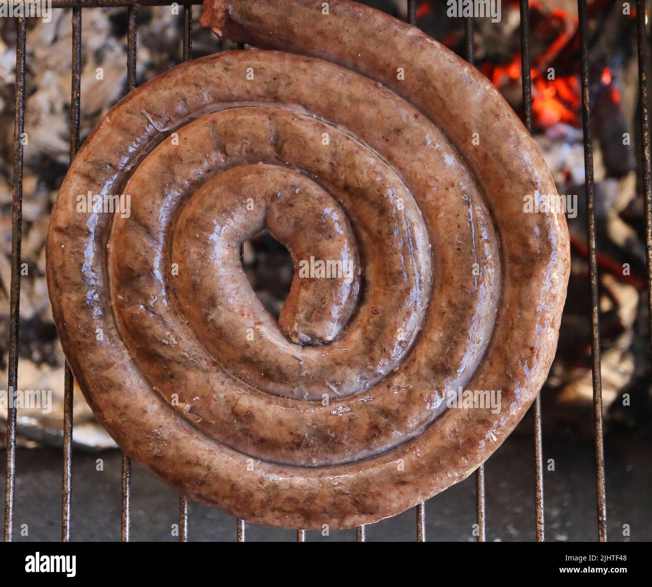Boerewors sausage on a braai. Boerewors or braai wors, a South African ...