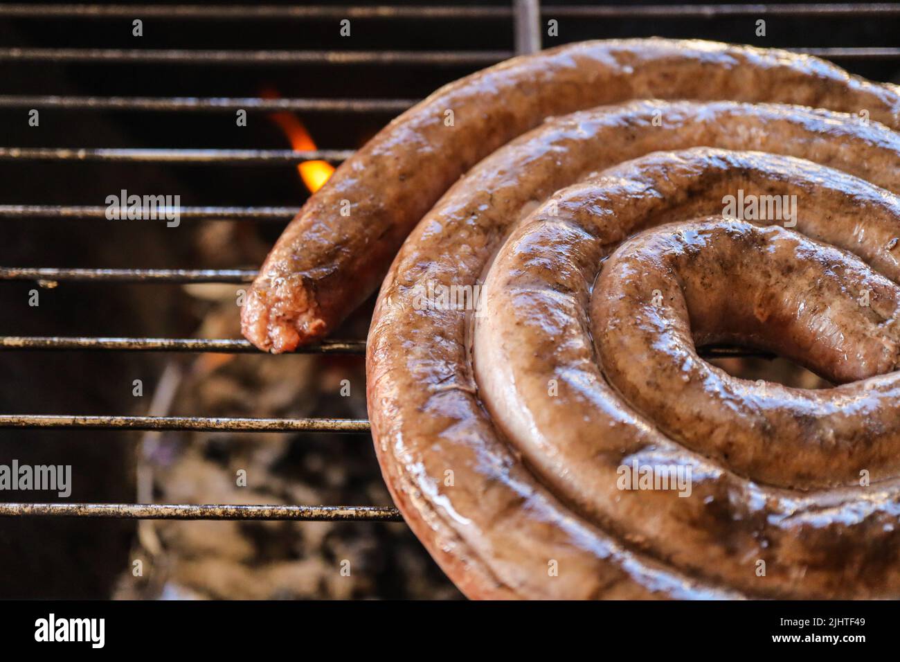 Boerewors sausage on a braai. Boerewors or braai wors, a South African ...