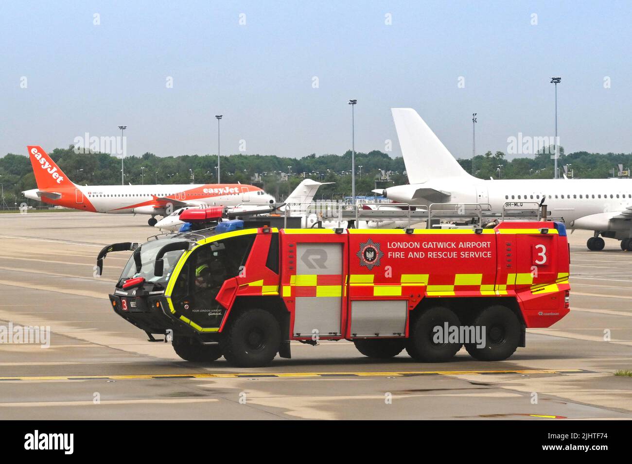 London, England - June 2022: Airport fire tender driving across the ...