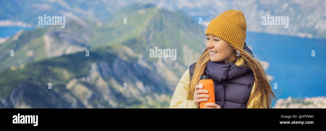 BANNER, LONG FORMAT Woman tourist enjoys the view of Kotor. Montenegro ...