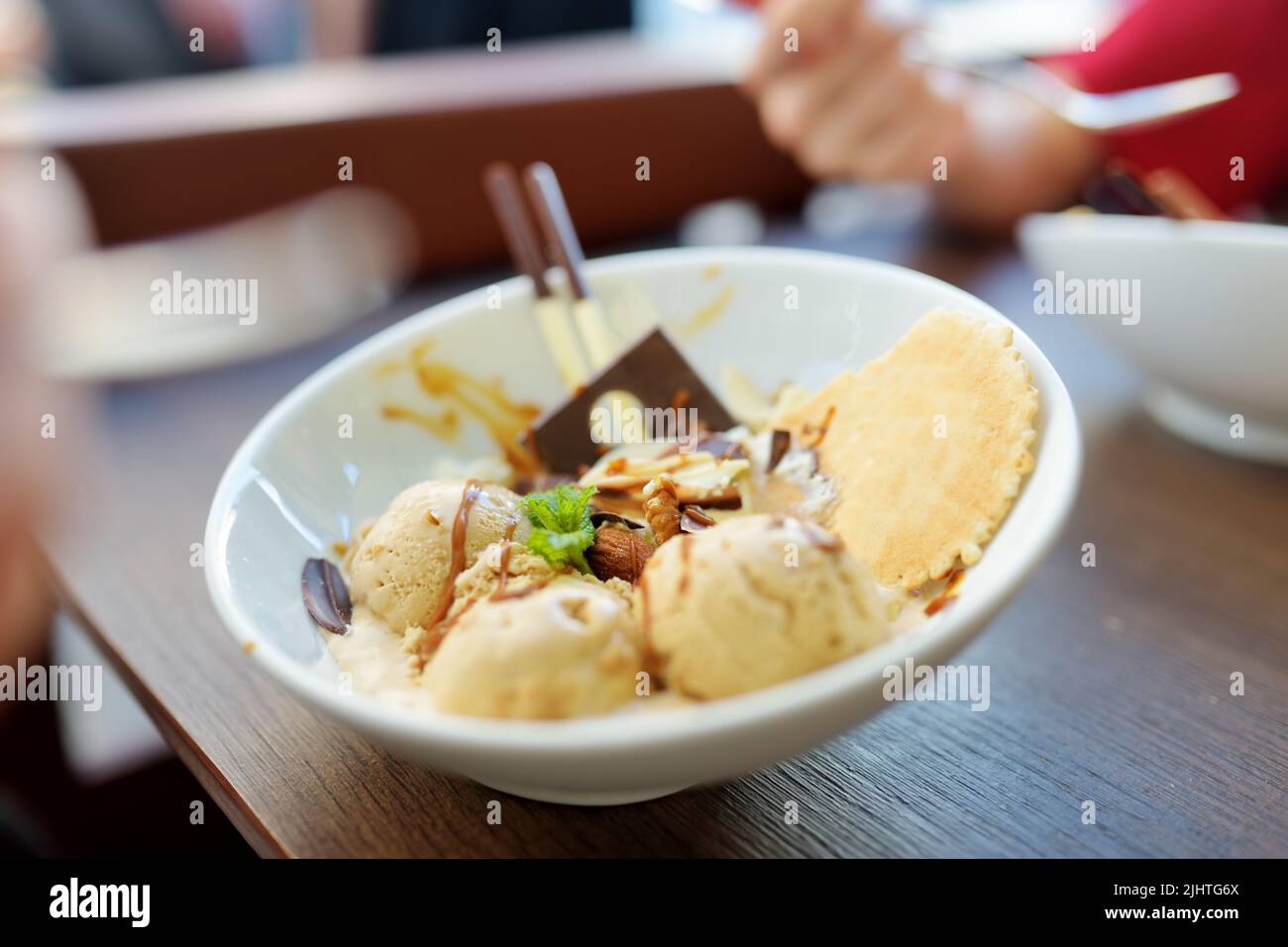 Delicious and appetizing ice cream dessert on a table. Cold caramel ice ...