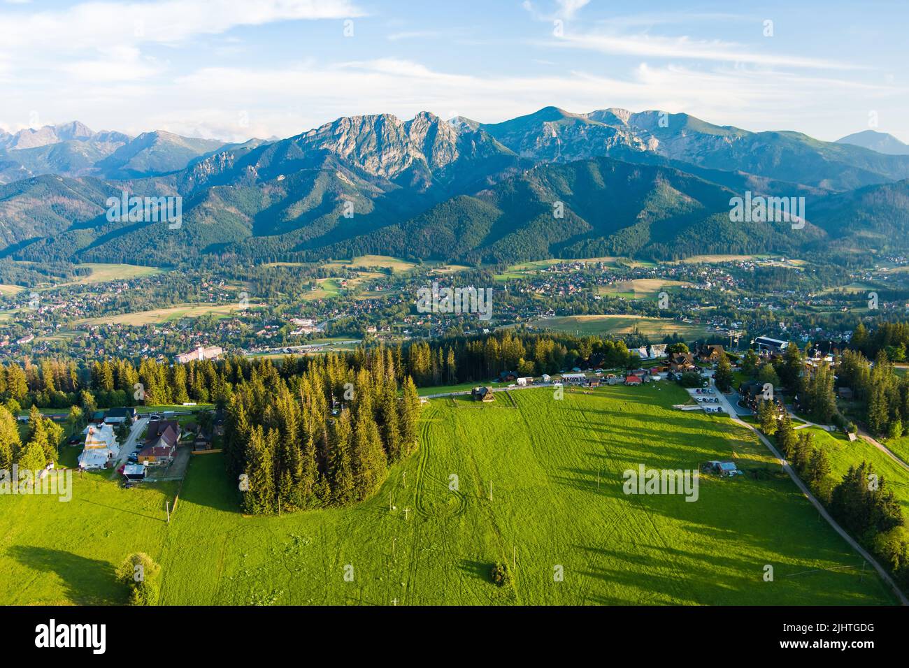 Aerial view of Zakopane town underneath Tatra Mountains taken from the ...