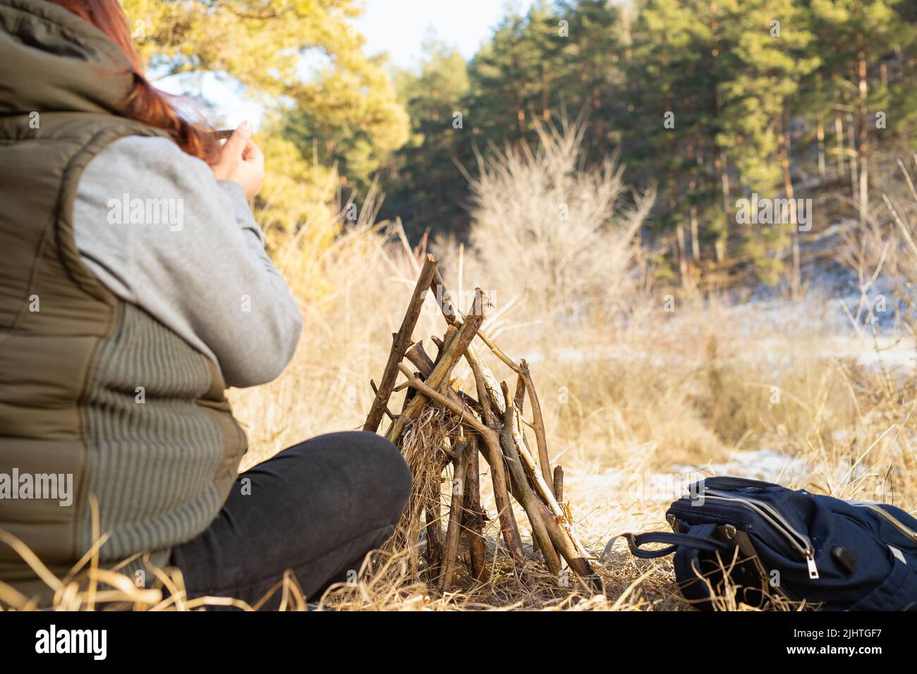 Back vie photo of a fat traveler woman sitting in front of the forest ...