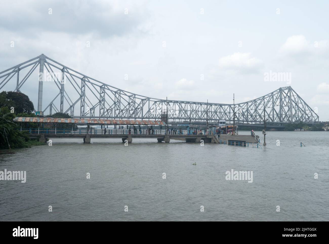 The Howrah Bridge, a balanced attached cantilever bridge covering over ...