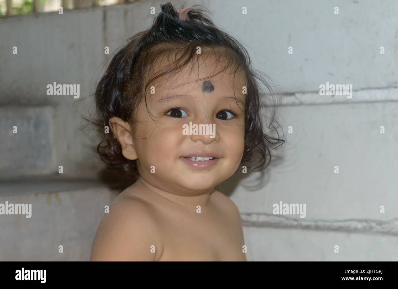 Cute happy indian baby without shirt smiling and looking at camera Stock Photo - Alamy