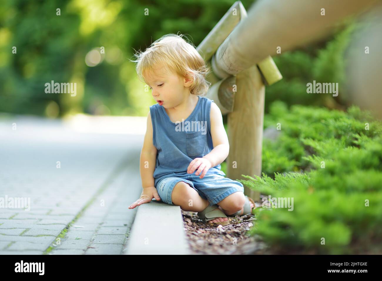 Funny toddler boy having fun outdoors on sunny summer day. Child ...