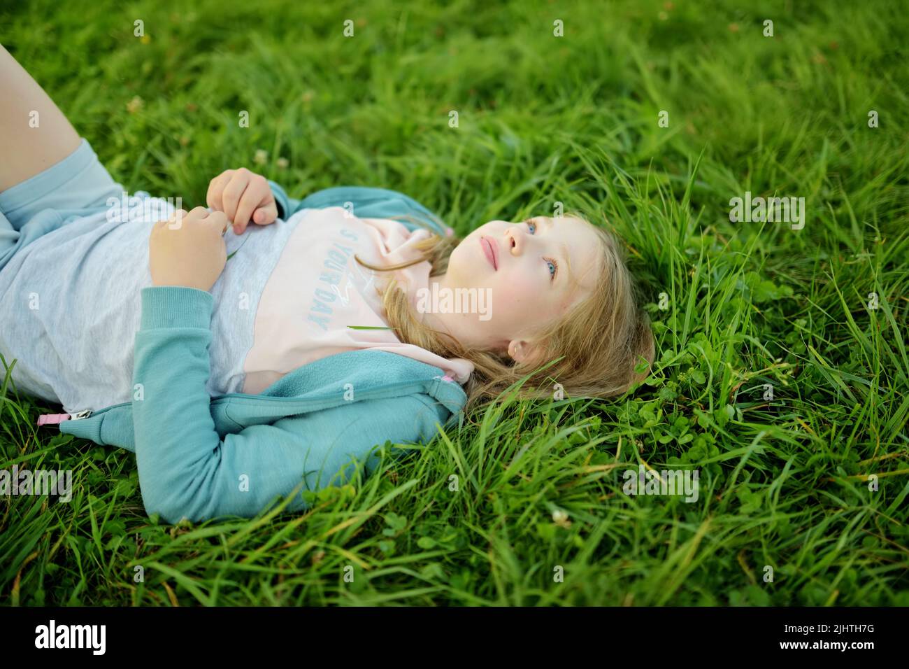 Cute young girl having fun outdoors on sunny summer day. Child ...