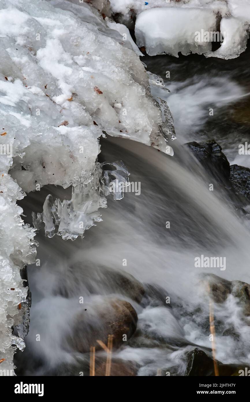 water flowing from the frozen ice Stock Photo - Alamy