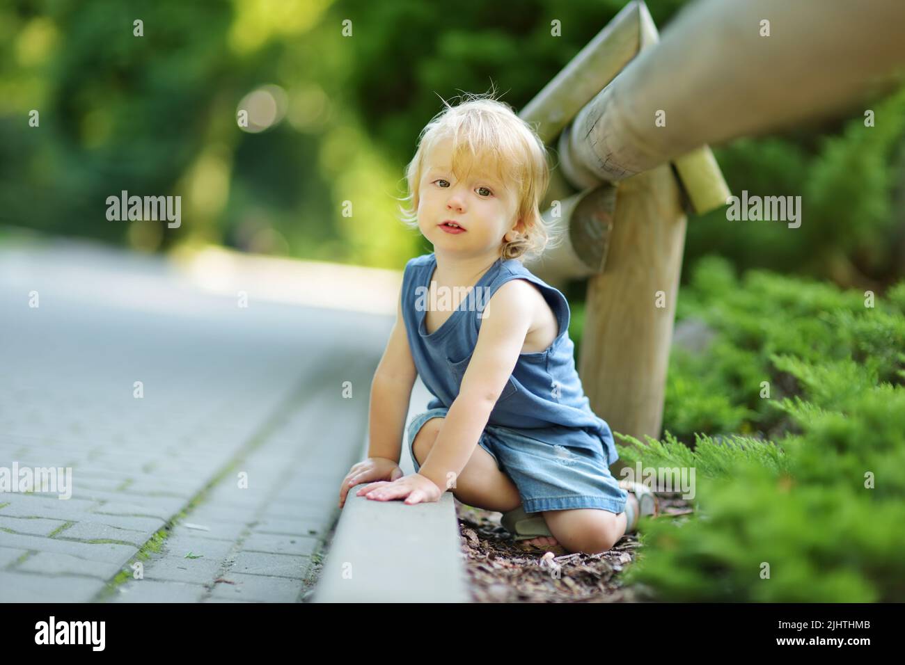 Funny toddler boy having fun outdoors on sunny summer day. Child ...
