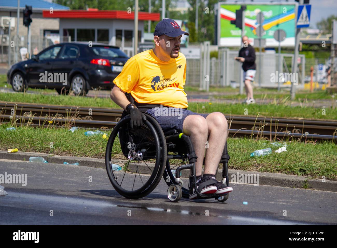 A disabled man on wheelchair in yellow shirt at Wings for Life World ...
