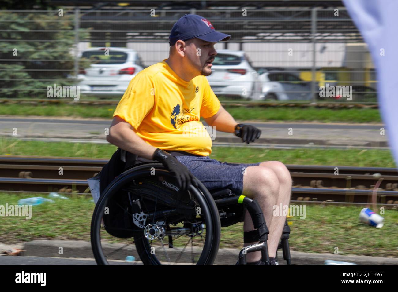 A disabled man on wheelchair in yellow shirt at Wings for Life World ...
