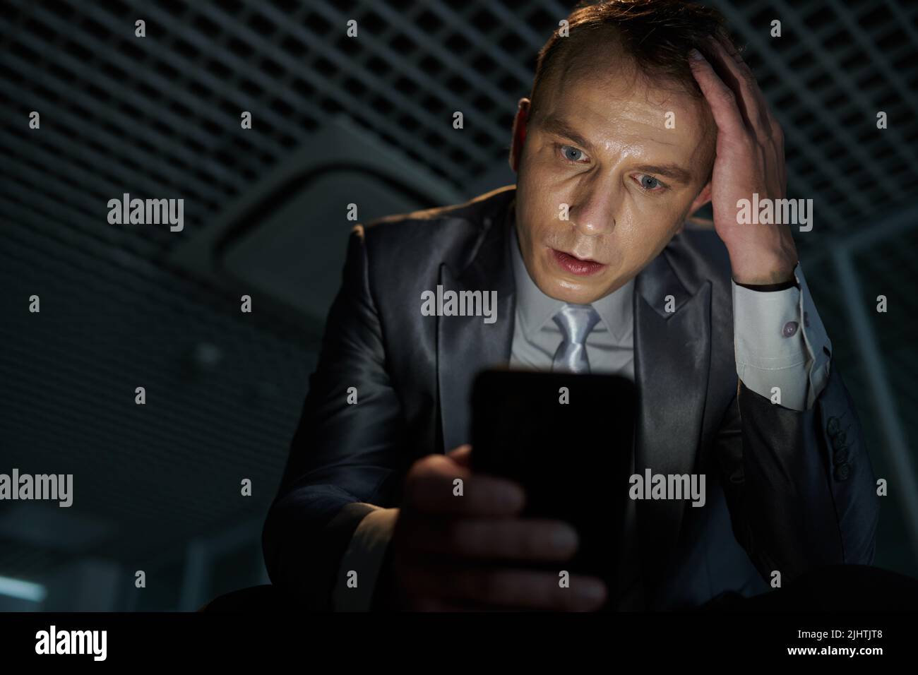 Shocked stress businessman touching his head when reading distressing ...