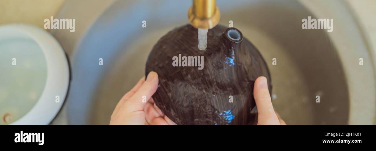 BANNER, LONG FORMAT Woman washing aroma diffuser in faucet ...