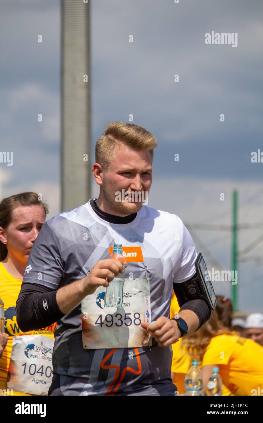 A male runner in white shirt at Wings for Life World Run Stock Photo ...