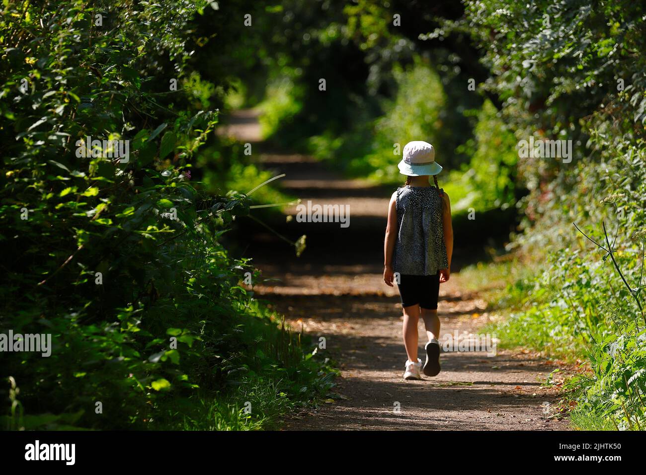 A 6 year old girl out walking along a public footpath between ...