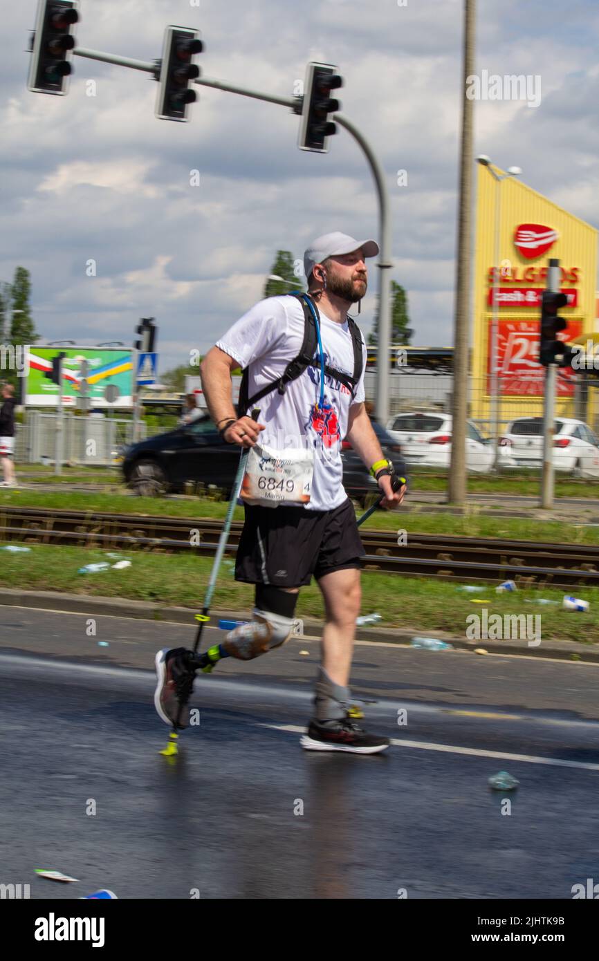A disabled man with sticks at Wings for Life World Run Stock Photo - Alamy