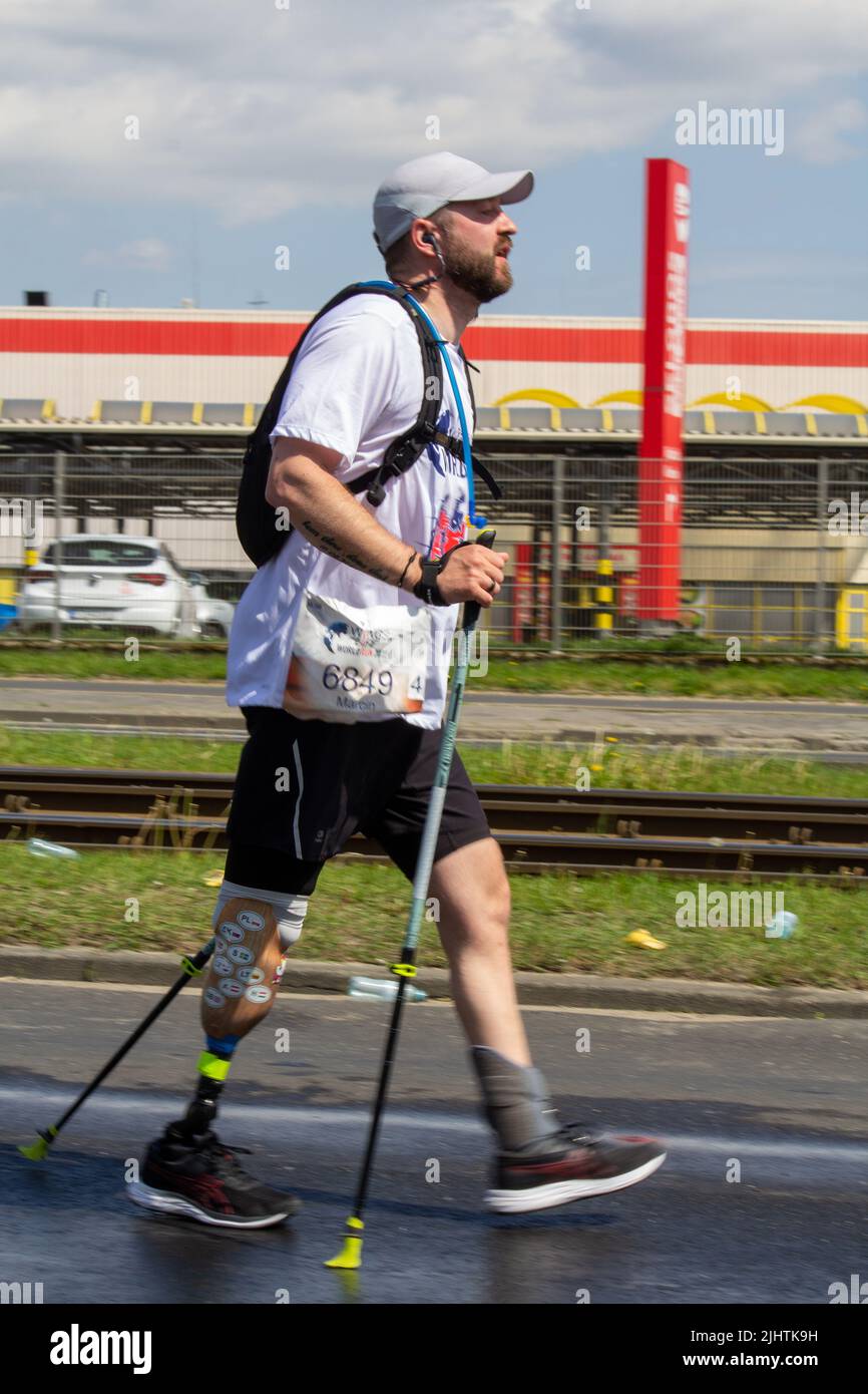 A disabled man with sticks at Wings for Life World Run Stock Photo - Alamy