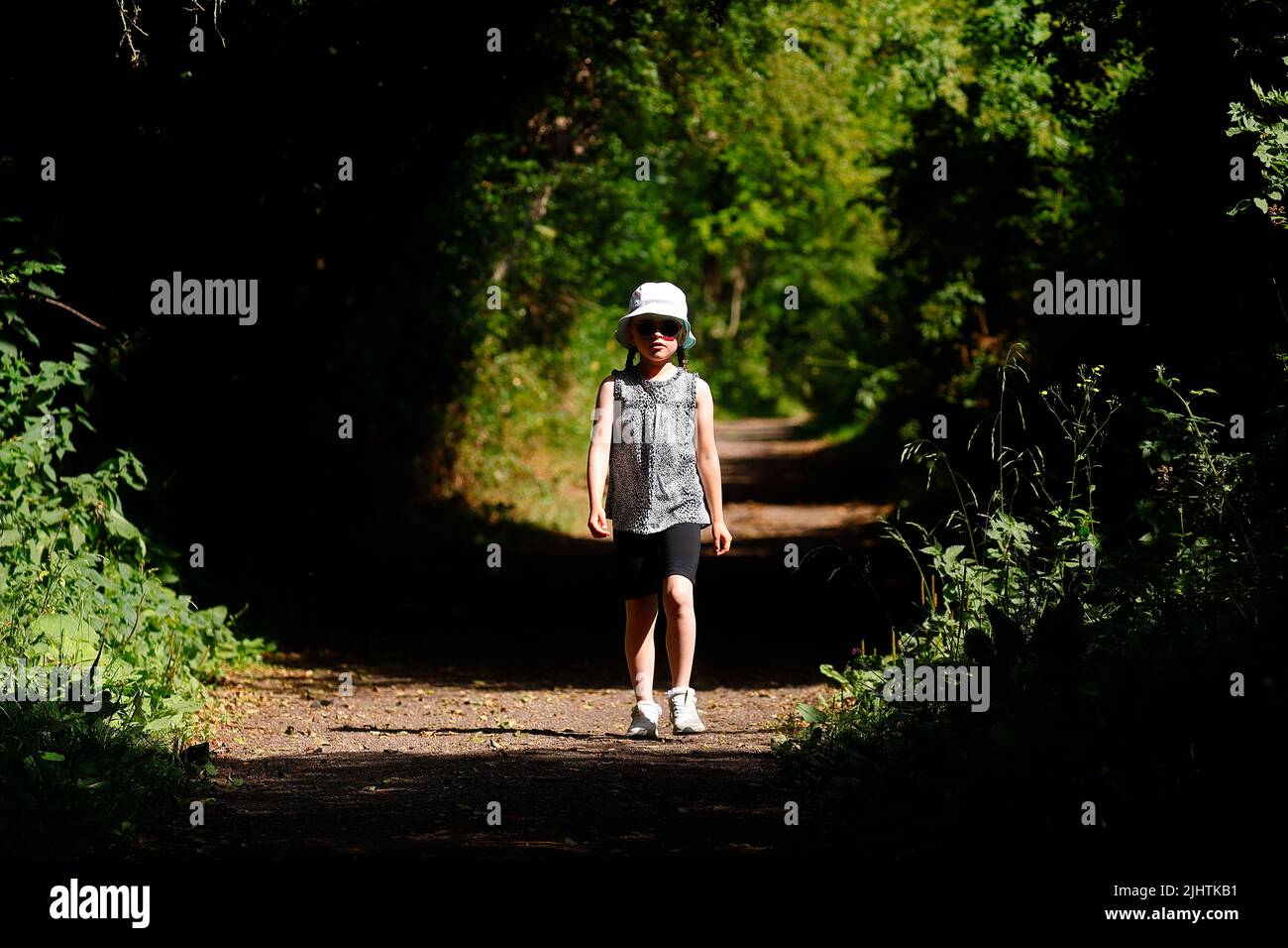 A 6 year old girl out walking along a public footpath between ...