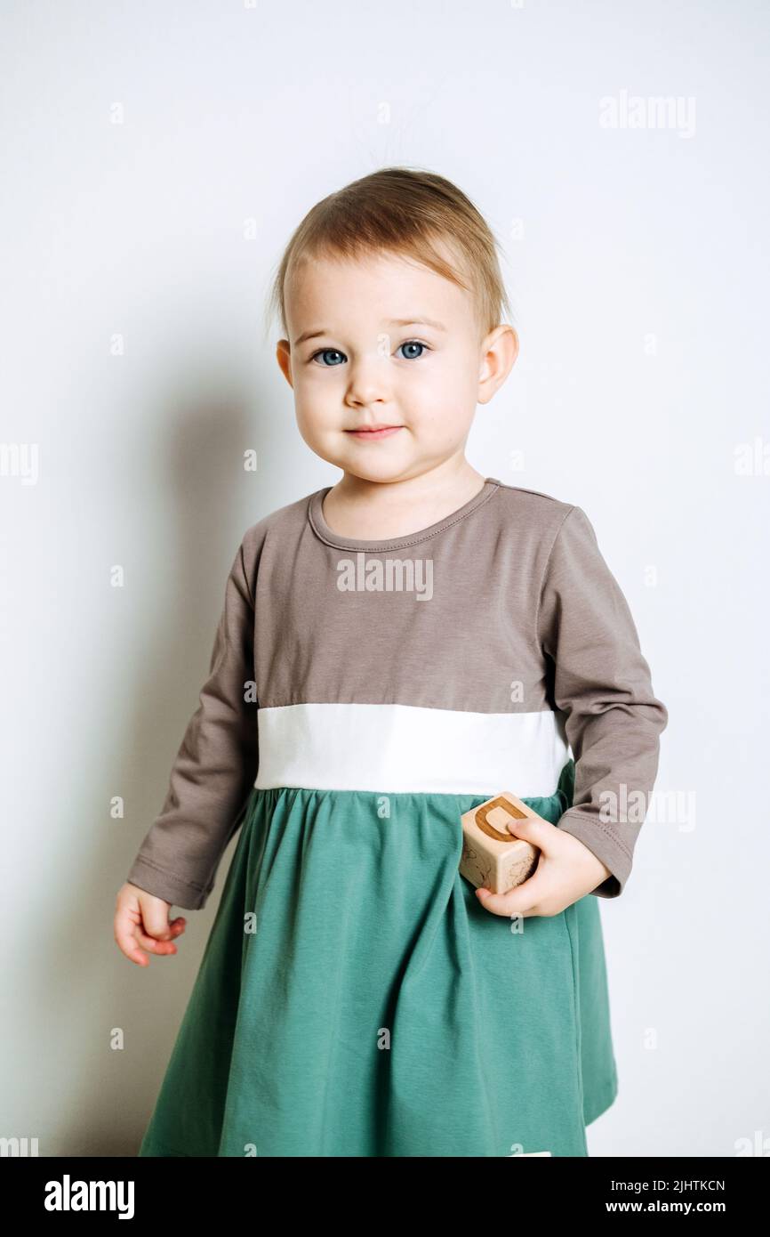 Baby fashion. Unisex color clothes for babies. Cute baby girls in ...