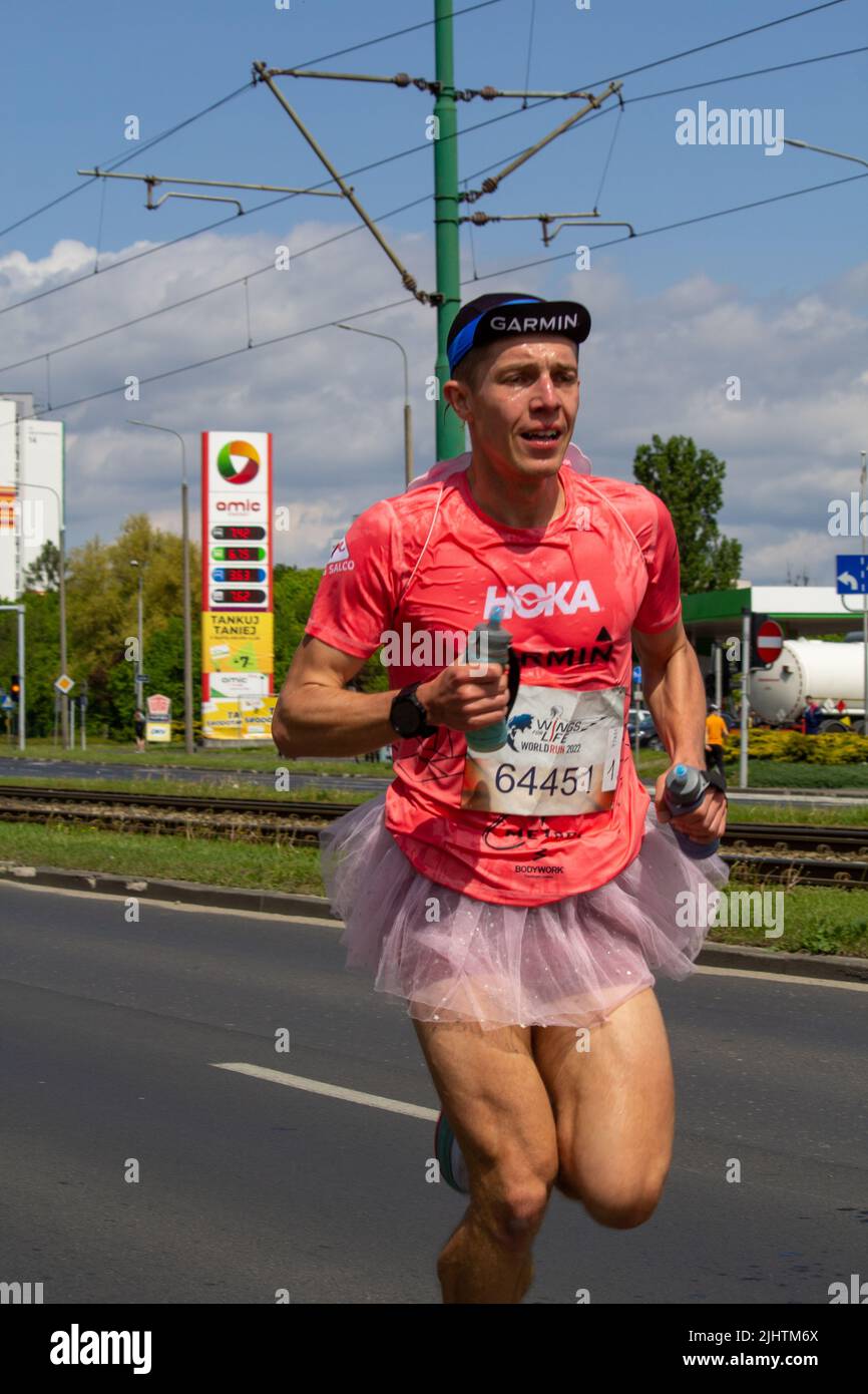 A male runner in pink skirt at Wings for Life World Run Stock Photo - Alamy