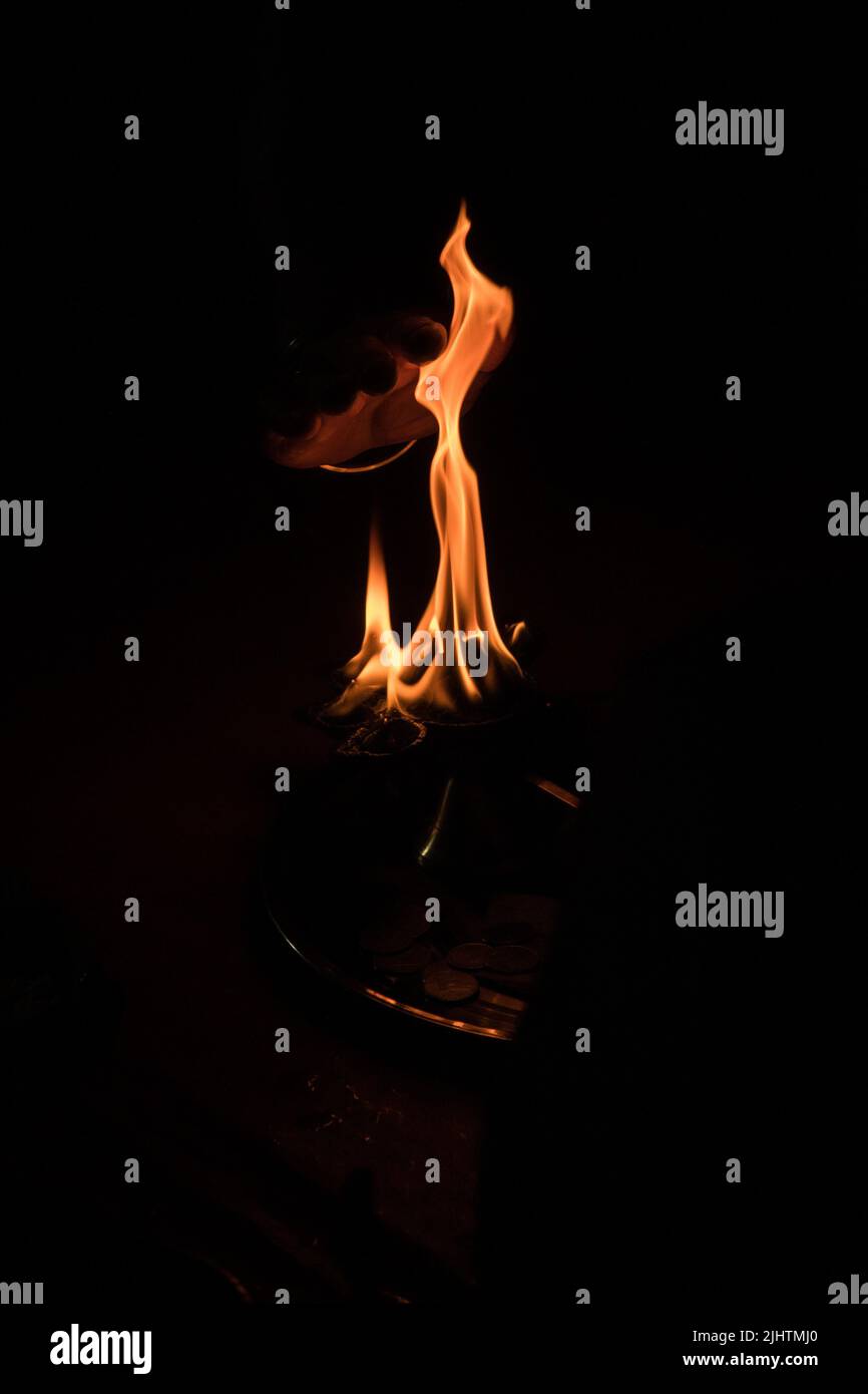 A vertical shot of a hand near the bonfire flame in the deep dark Stock ...