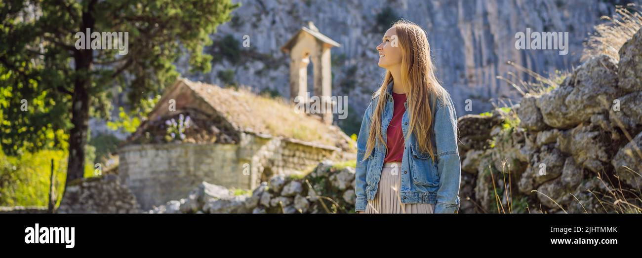 BANNER, LONG FORMAT Woman tourist enjoys the view of Kotor. Montenegro ...