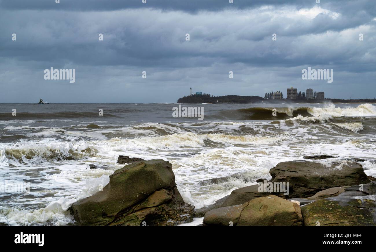 Restless sea waves washing over a rocky beach after a storm Stock Photo ...