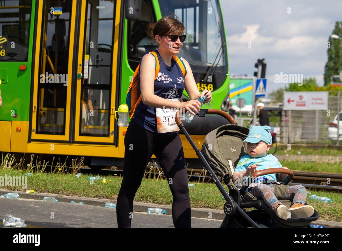 A female participant with baby carriage at Wings for Life World Run ...