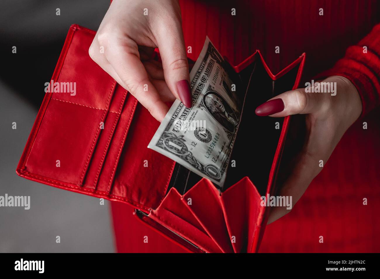 Red wallet in the hands of woman in a red dress with red manicur Stock ...