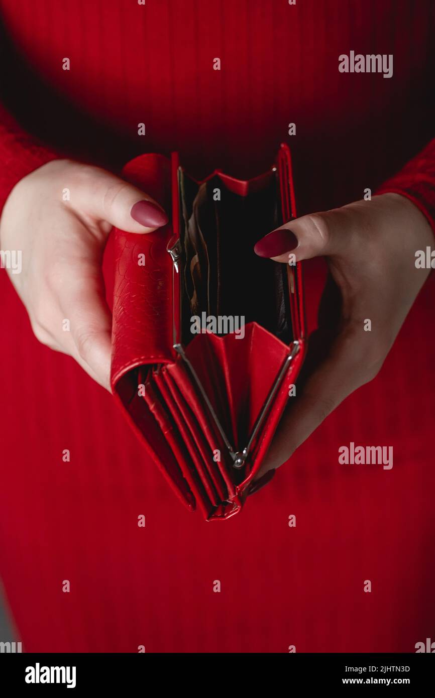 Red wallet in the hands of woman in a red dress with red manicur Stock ...