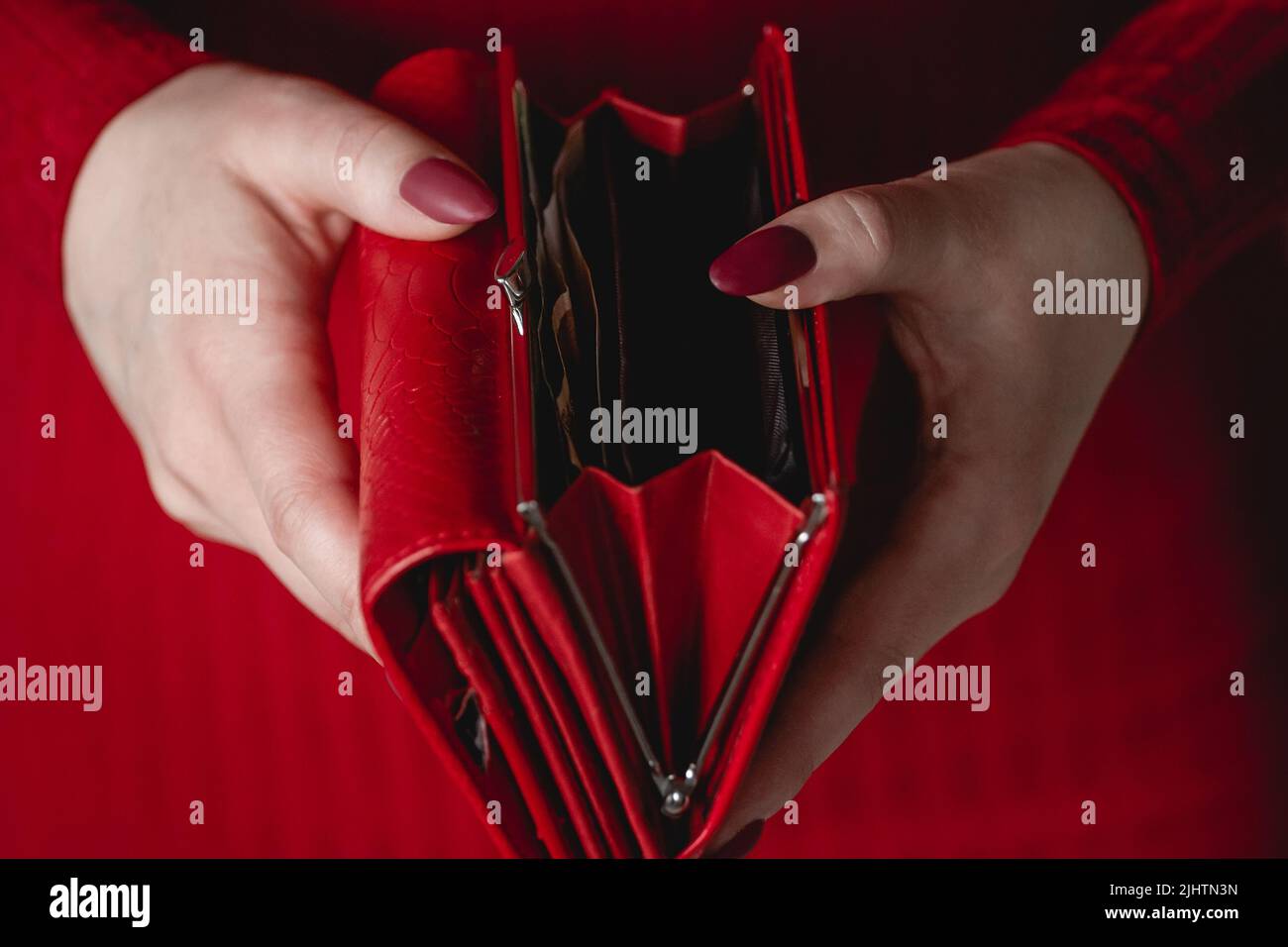 Red wallet in the hands of woman in a red dress with red manicur Stock ...