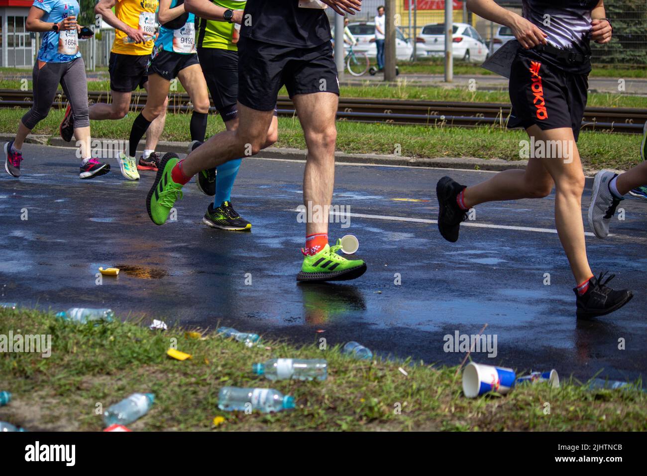 The participants of the race run by a water station with bottles and ...