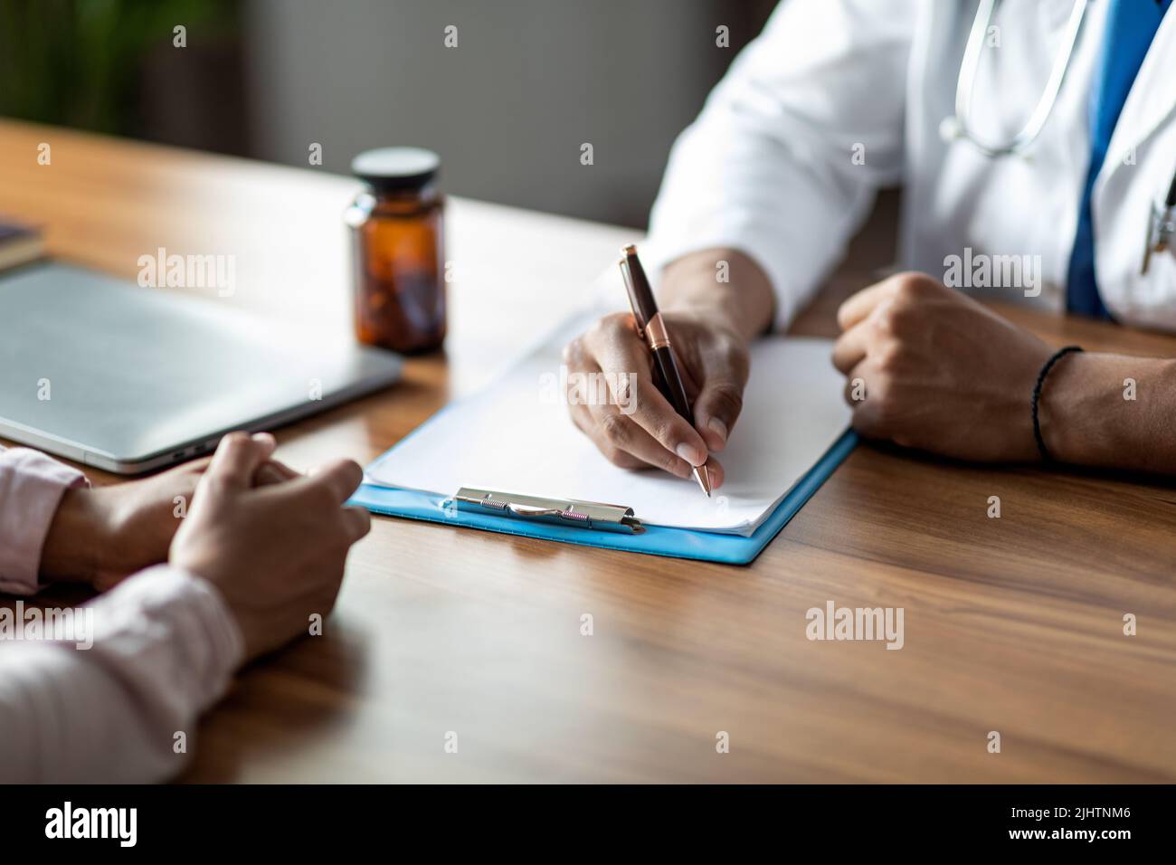Unrecognizable doctor taking anamnesis of female patient Stock Photo ...