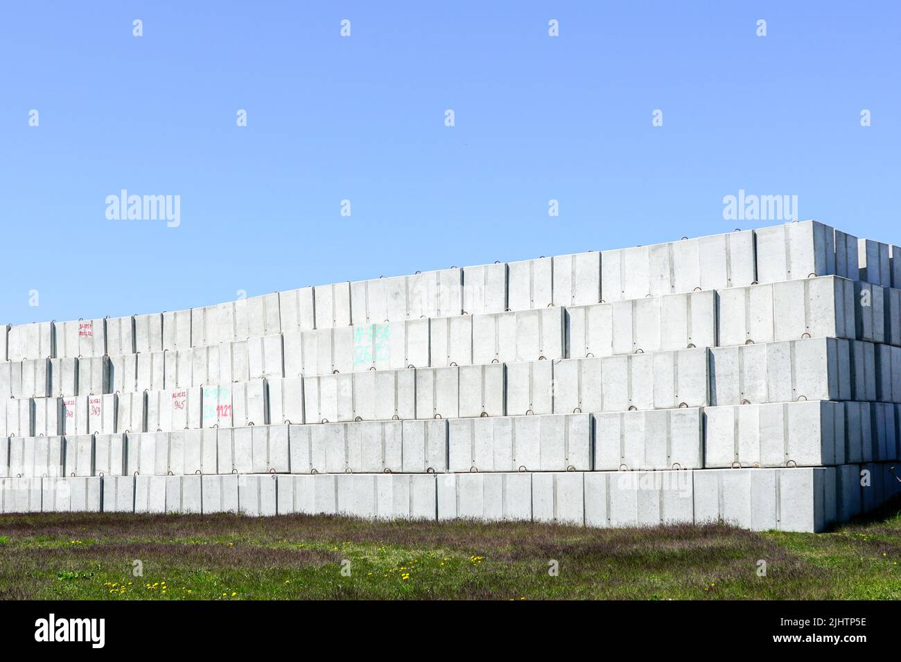 Stack of many large white concrete cube shaped blocks in the factory ...