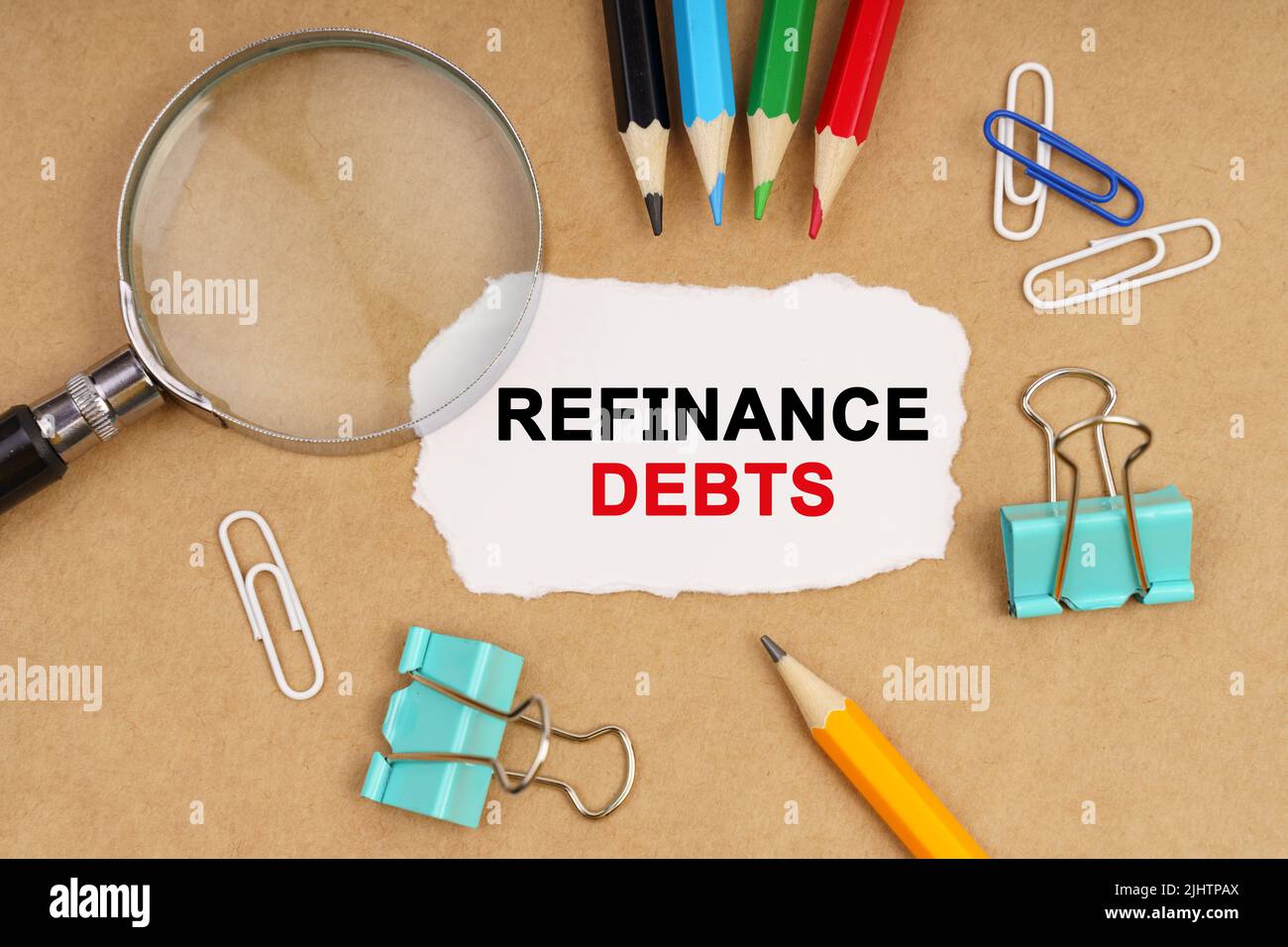 Business concept. On the table are pencils, paper clips, a magnifying ...