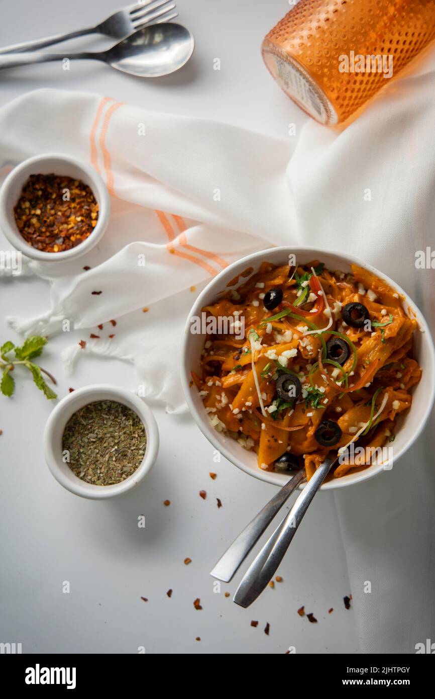A vertical top view of an aesthetic table salad and seasonings for ...