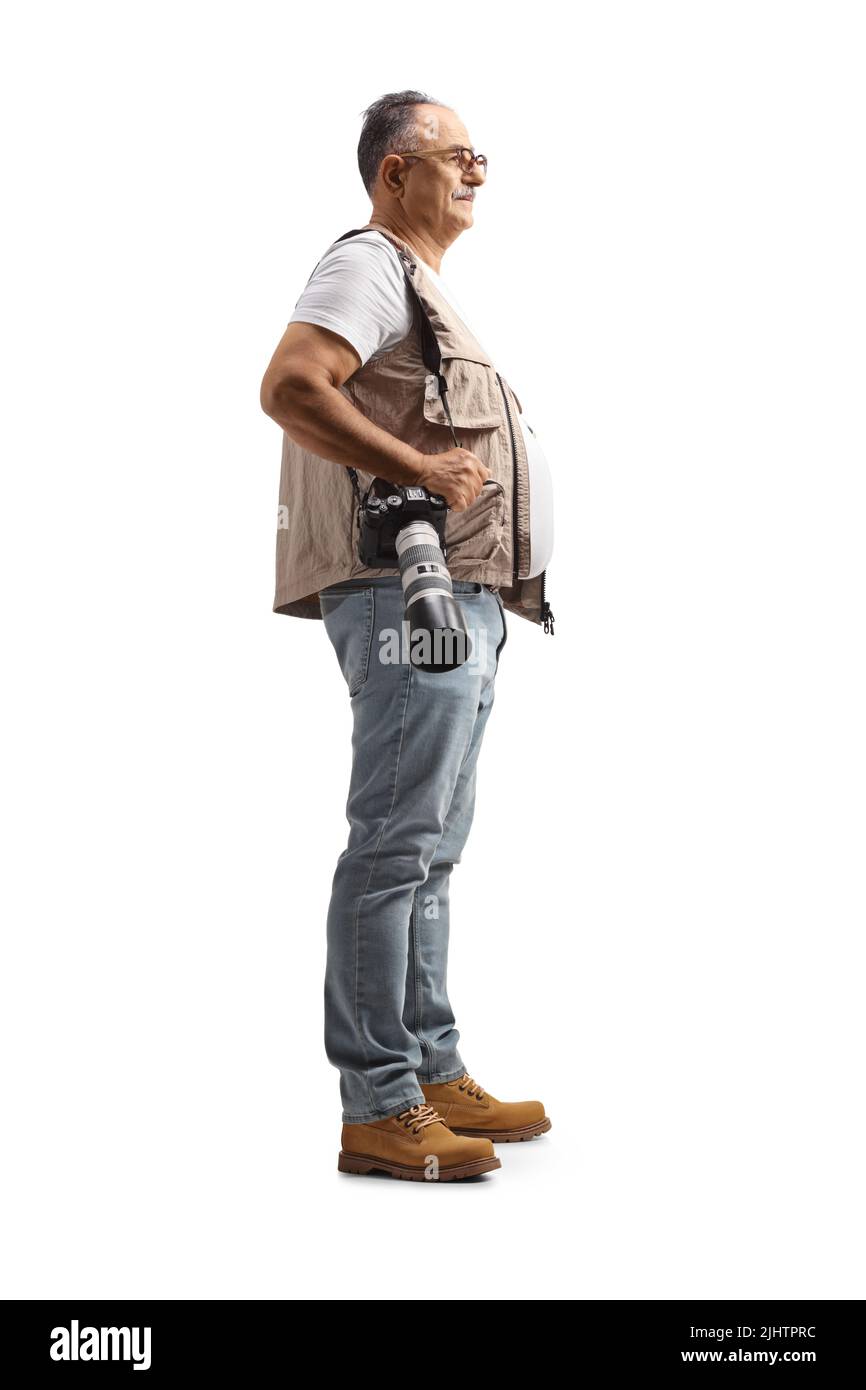 Full length profile shot of a photographer standing with a camera on ...