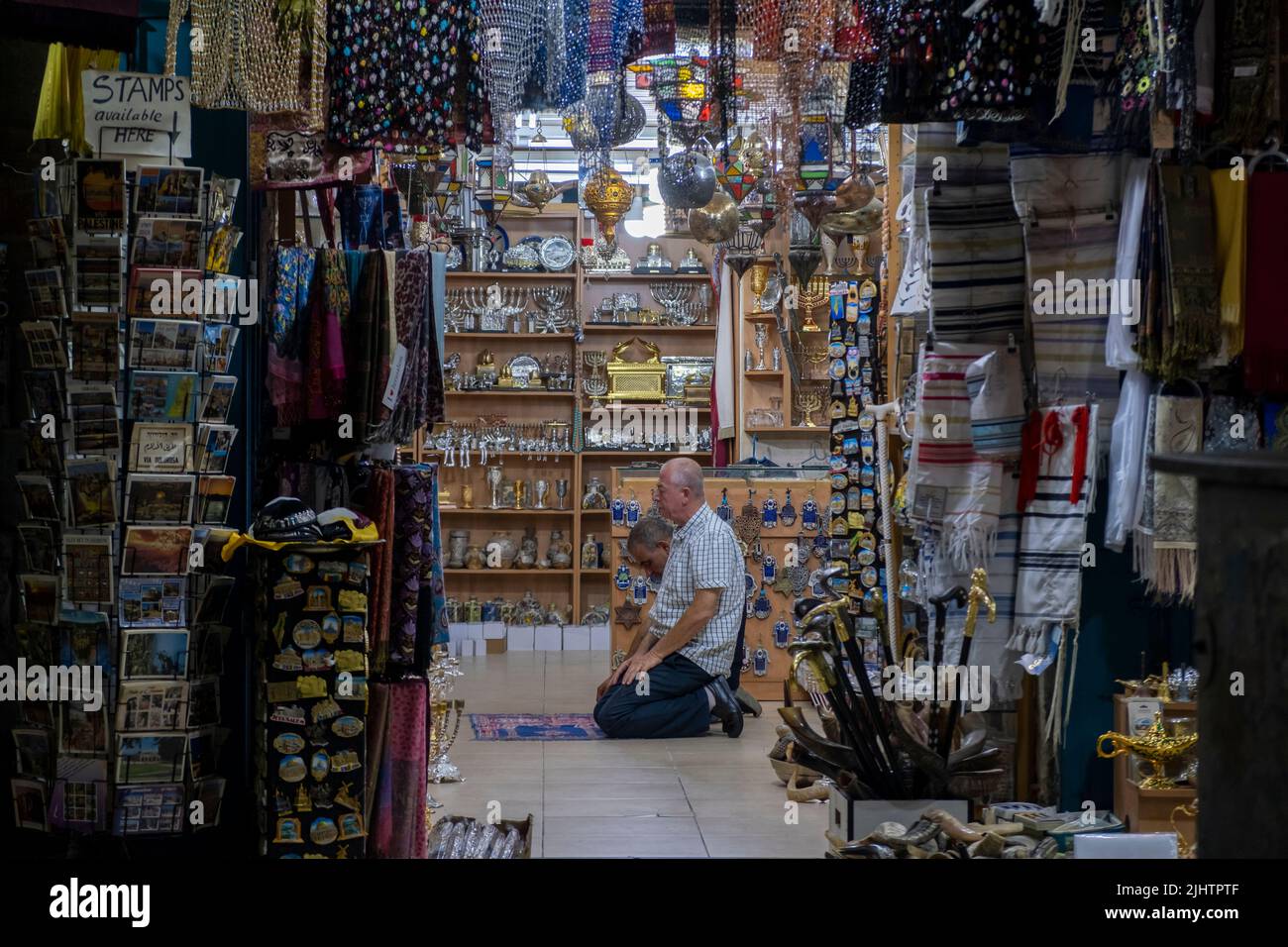 Palestinian men pray inside a souvenir shop at the old city East ...