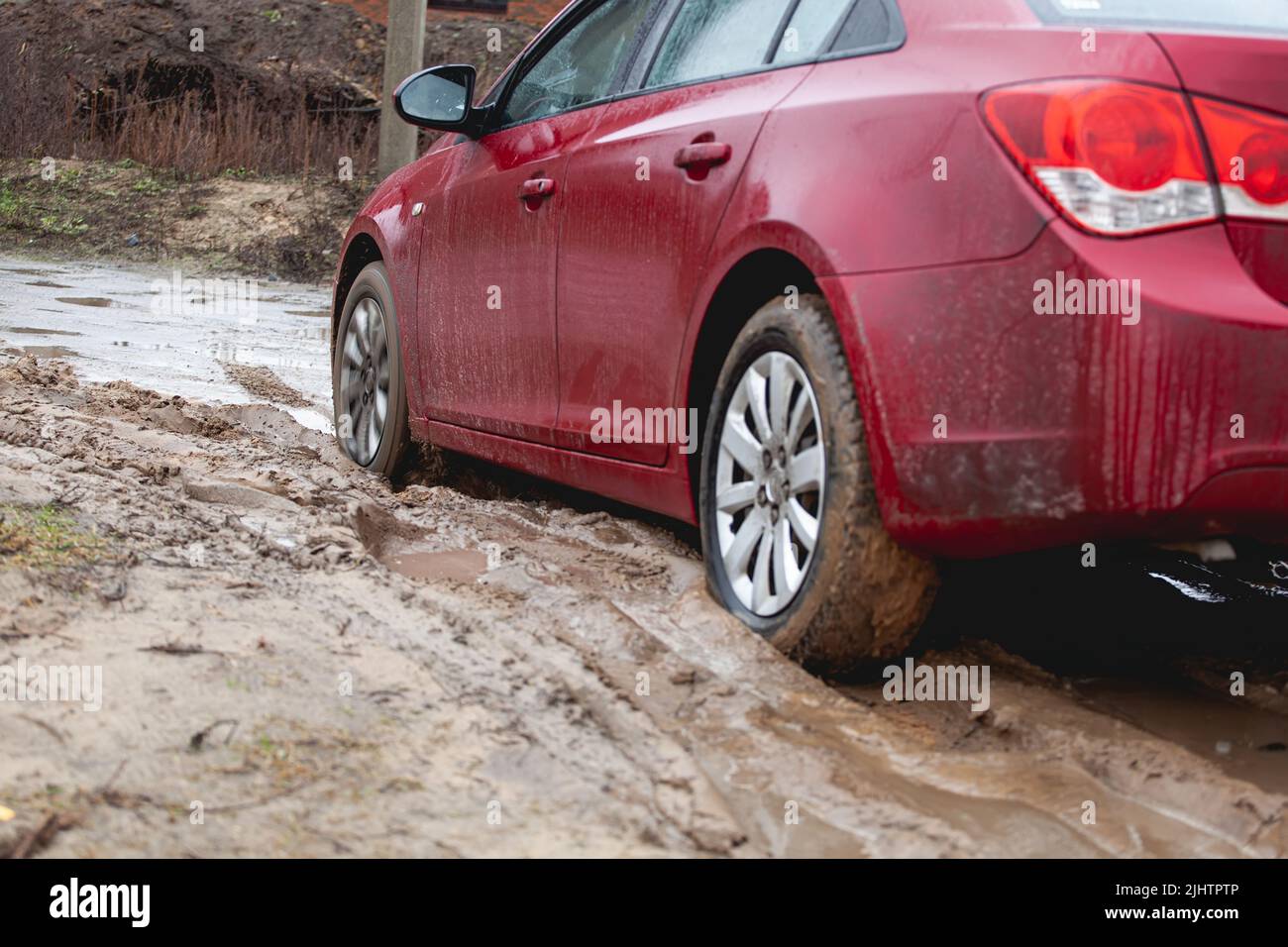 Car stuck in the mud, car wheel in dirty puddle, rough terrain Stock ...