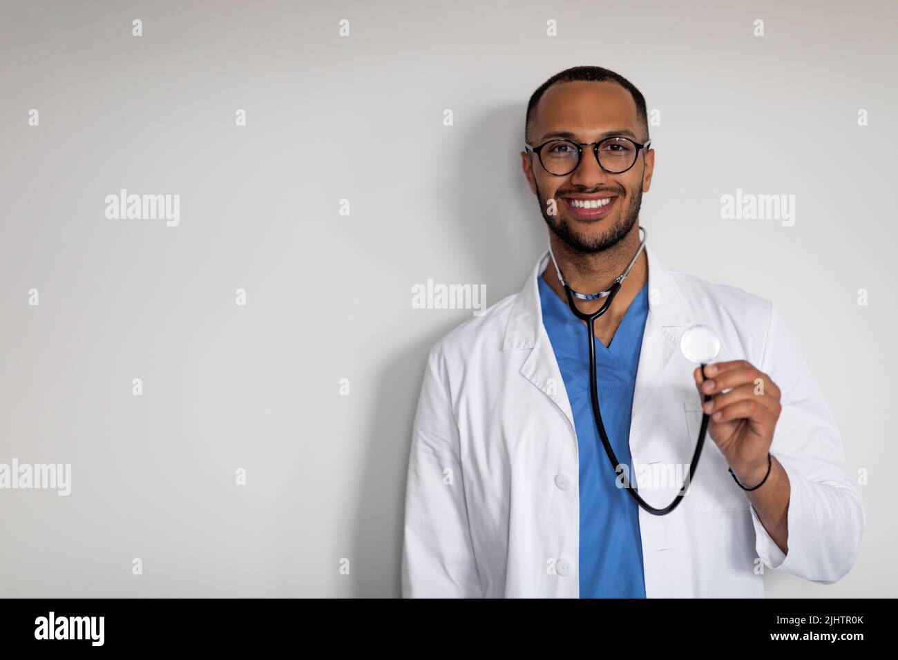 Portrait of cheerful arab doctor holding stethoscope Stock Photo - Alamy