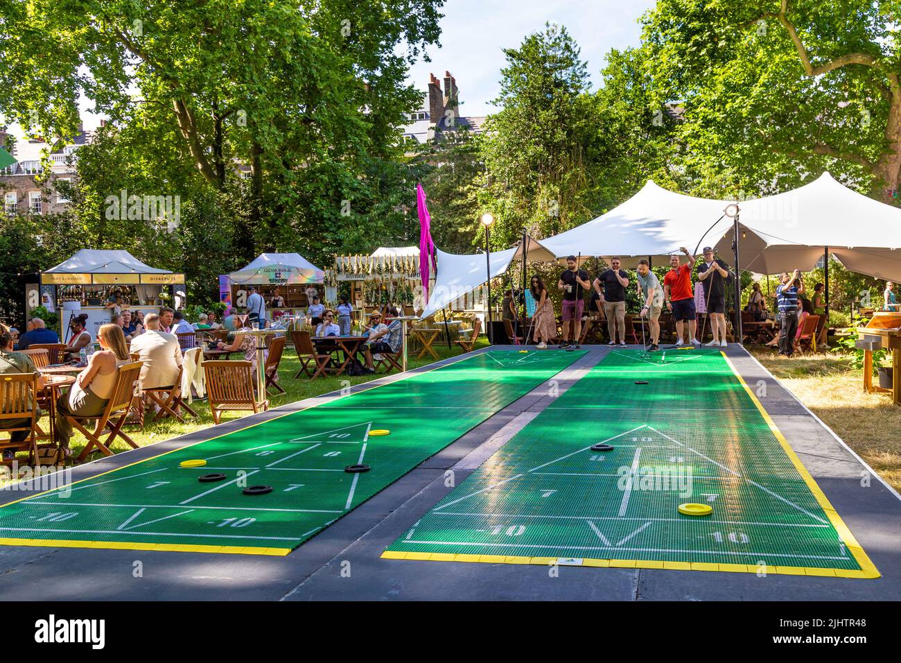 People playing shuffleboard outdoors at Cocktails in the City event in ...