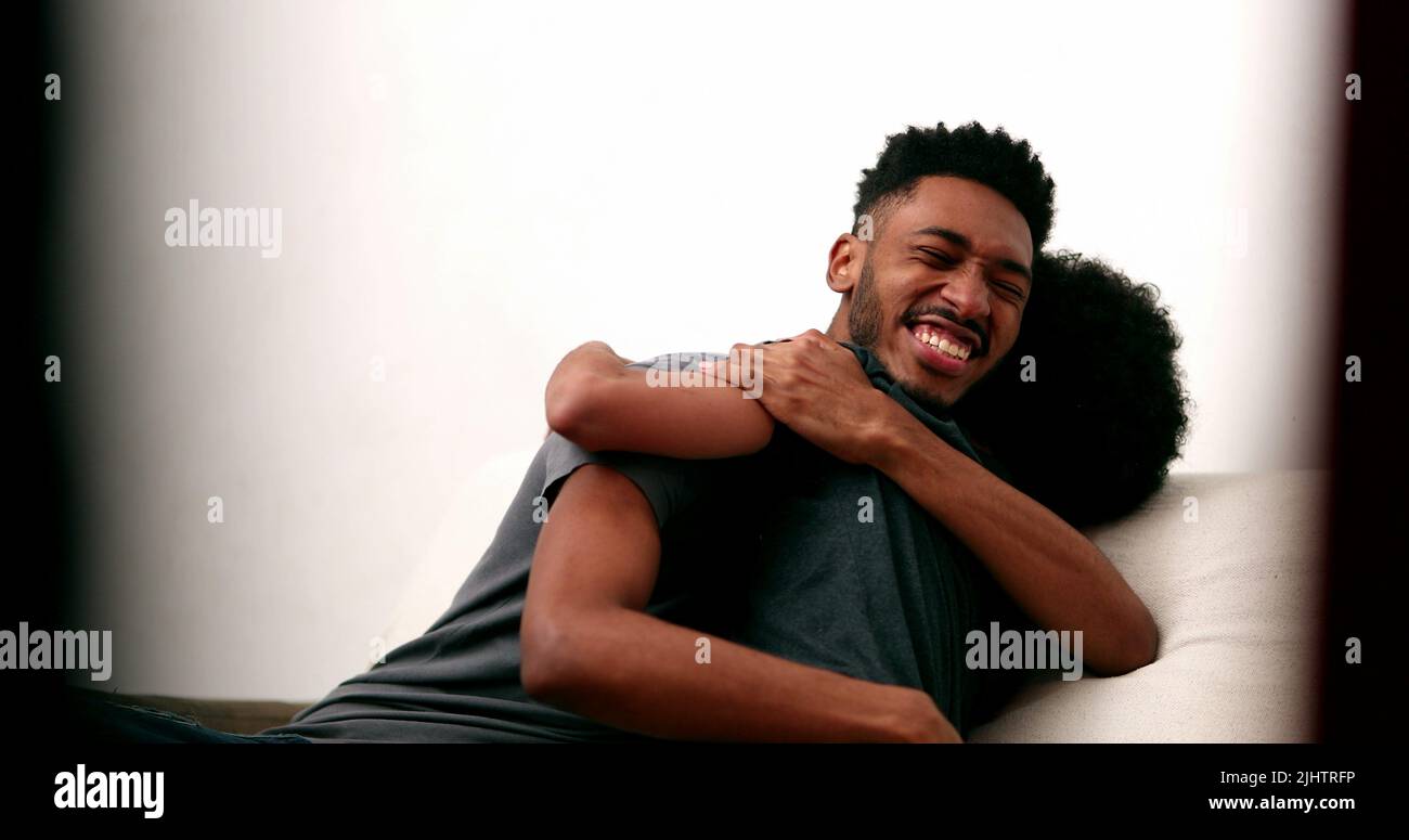 Two african brothers bonding and hugging each other. Candid siblings ...