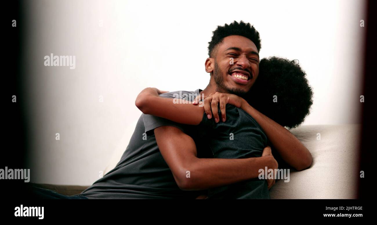 Two african brothers bonding and hugging each other. Candid siblings ...