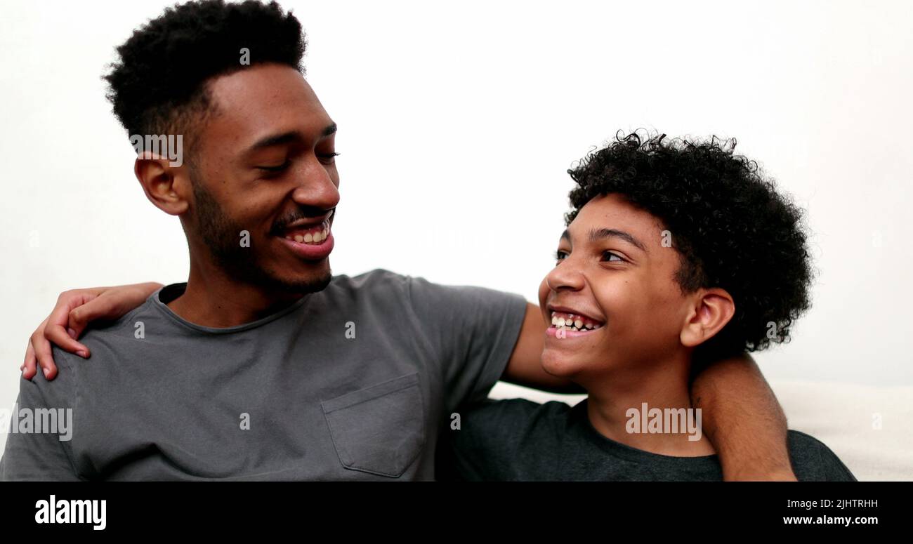 Two brothers relationship laughing and smiling together. Older and ...