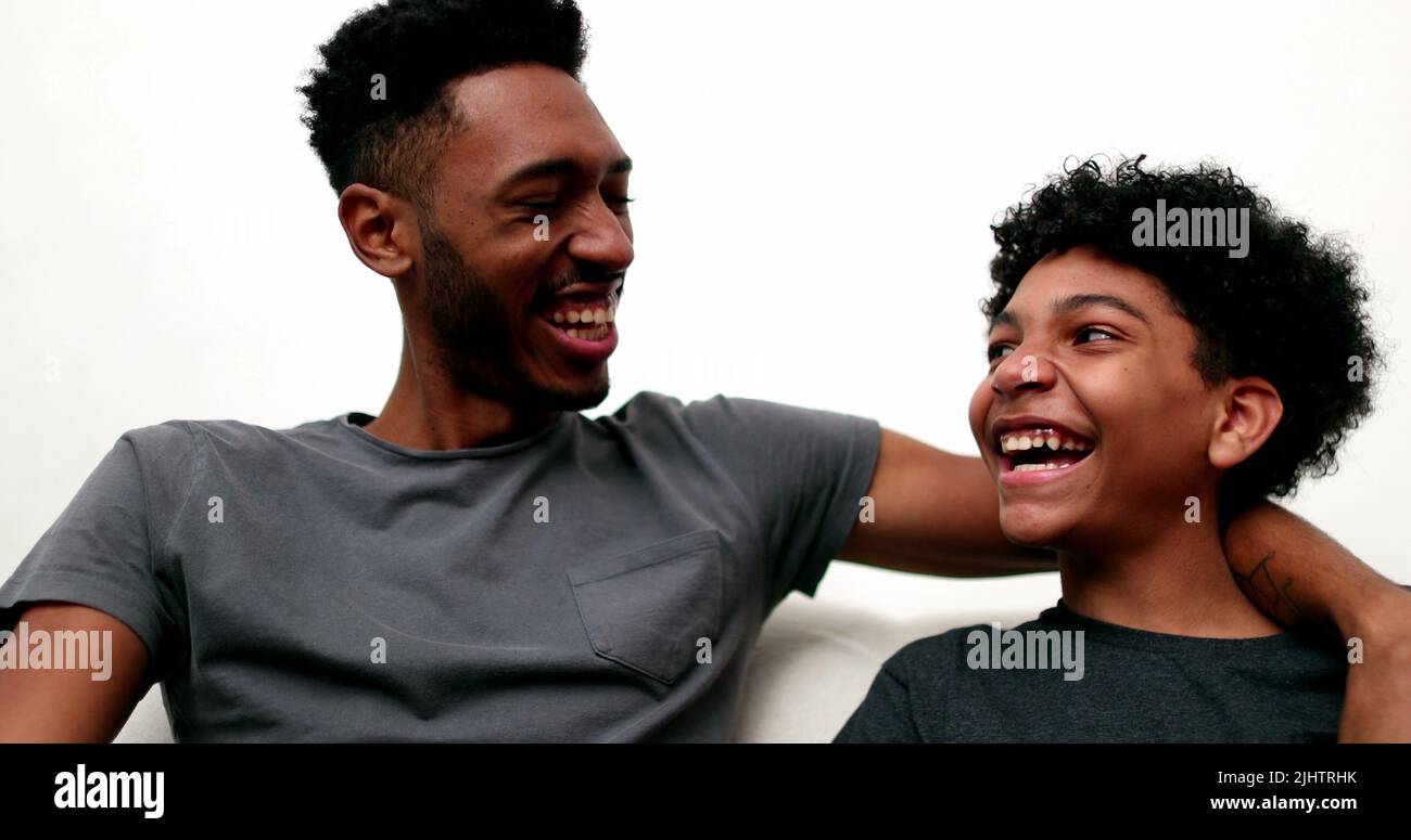 Two brothers relationship laughing and smiling together. Older and ...
